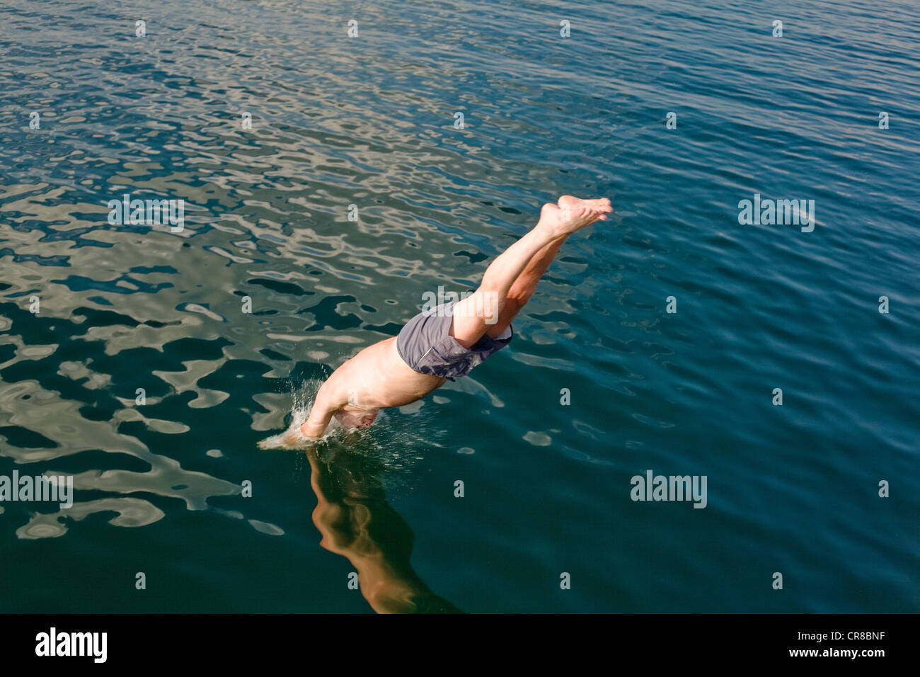 Man diving into sea Stock Photo - Alamy
