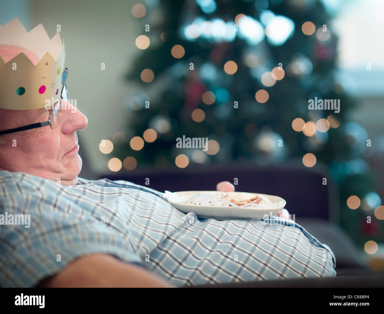 Senior man wearing party hat asleep Stock Photo - Alamy