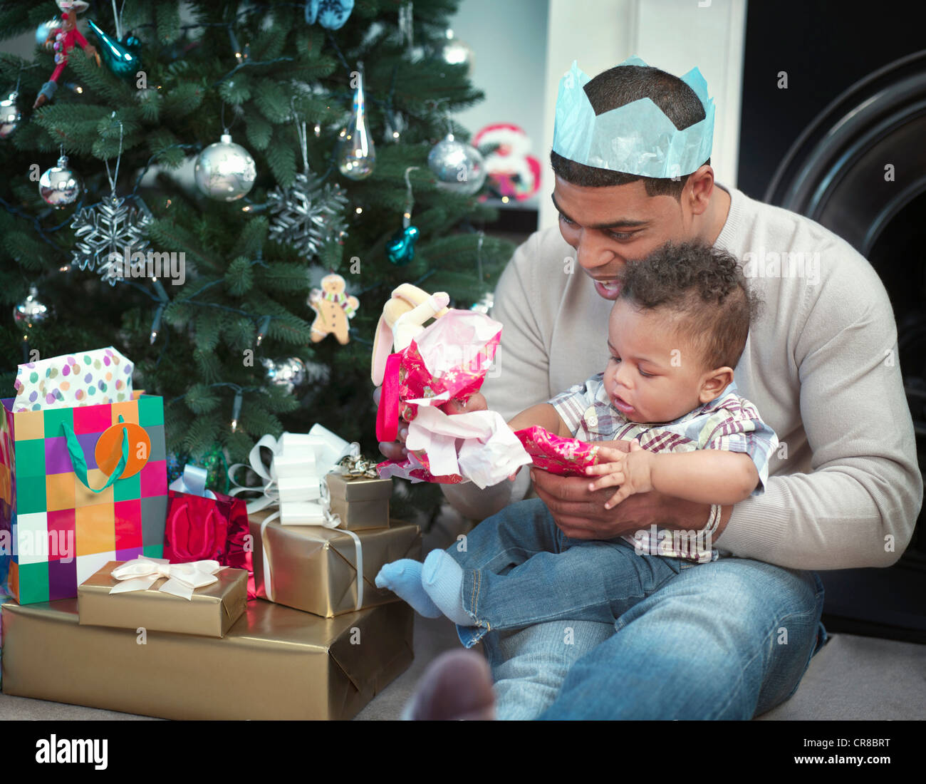 Father and baby boy opening christmas presents Stock Photo - Alamy