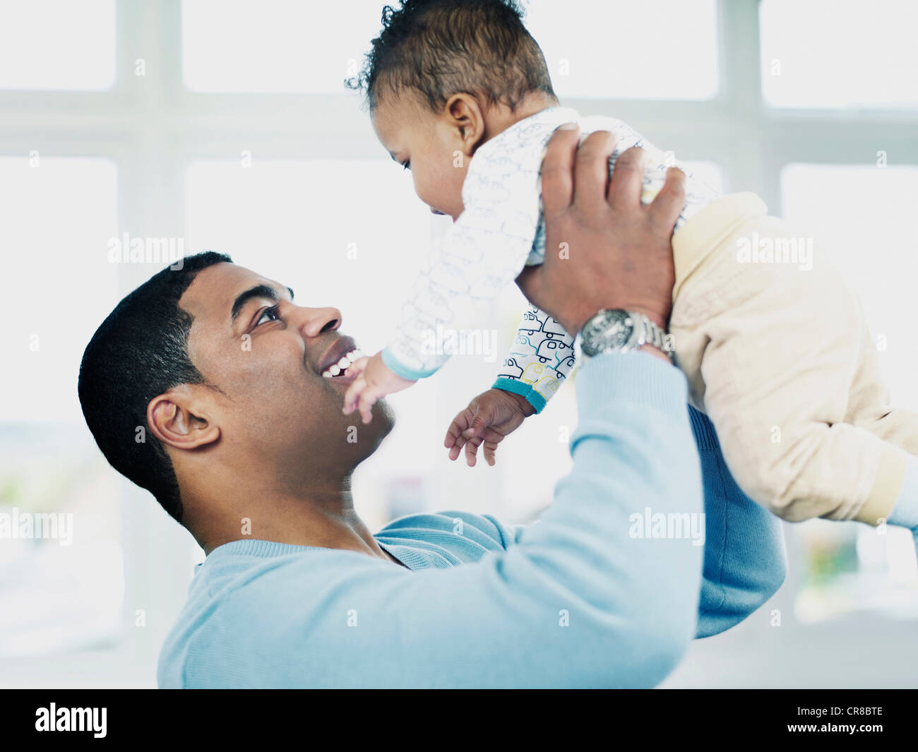 Father lifting baby boy Stock Photo - Alamy