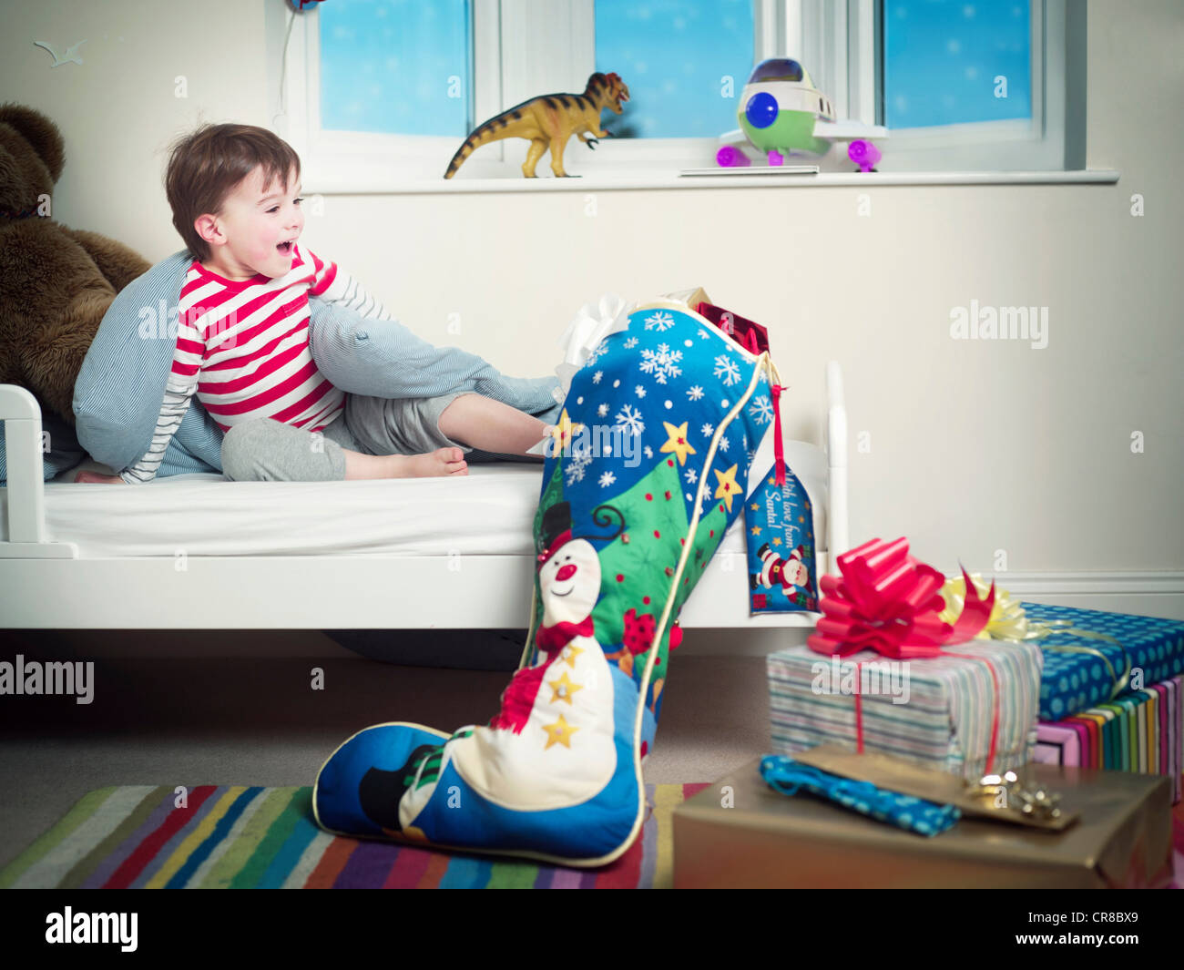 Boy opening christmas presents Stock Photo - Alamy