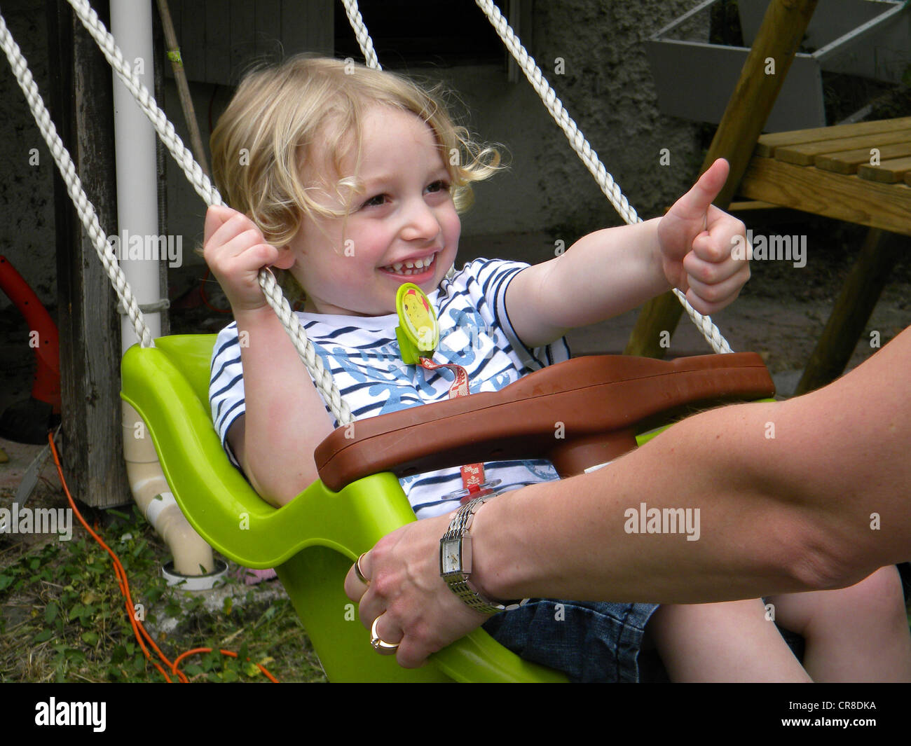 Boy on swing Stock Photo - Alamy