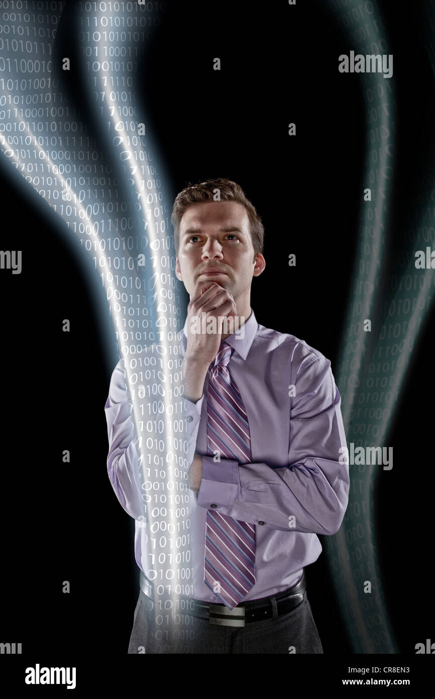 Businessman looking at data streams Stock Photo - Alamy