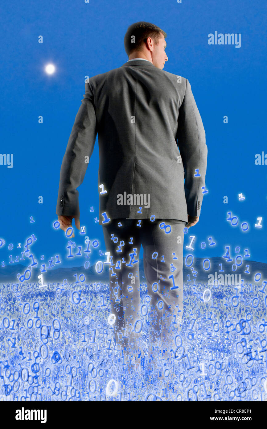 Businessman walking through binary field Stock Photo - Alamy