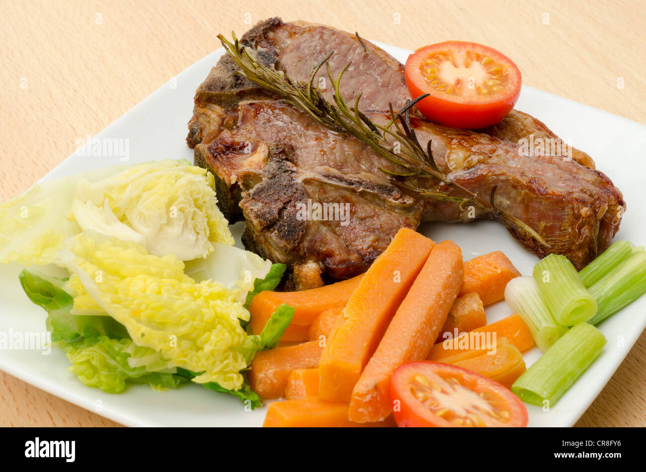 Two grilled lamb chops with steamed vegetables Stock Photo - Alamy