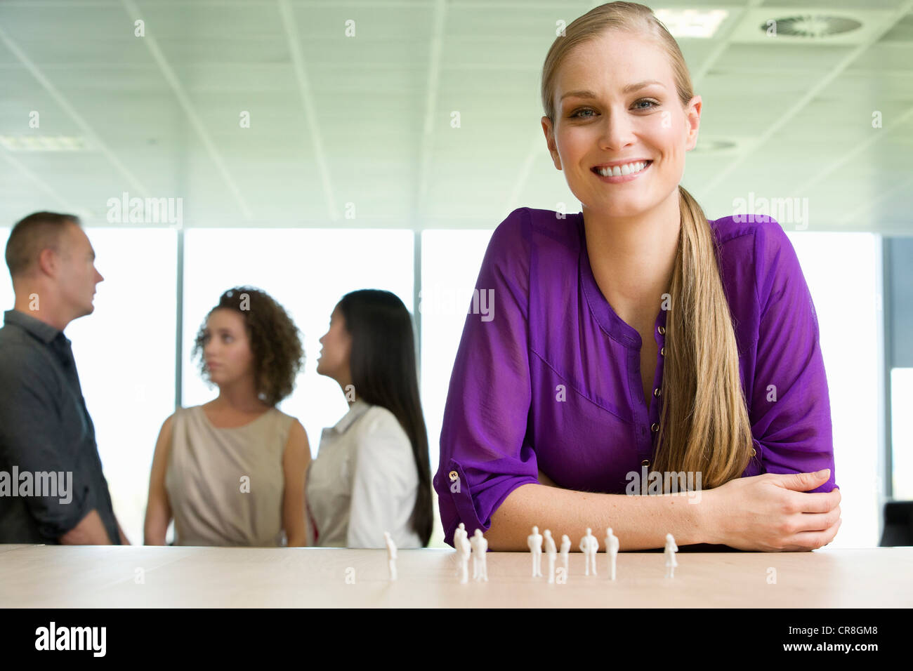 Young architect sitting at desk with model figures Stock Photo - Alamy Young architect sitting at desk with model figures Stock Photo - Alamy