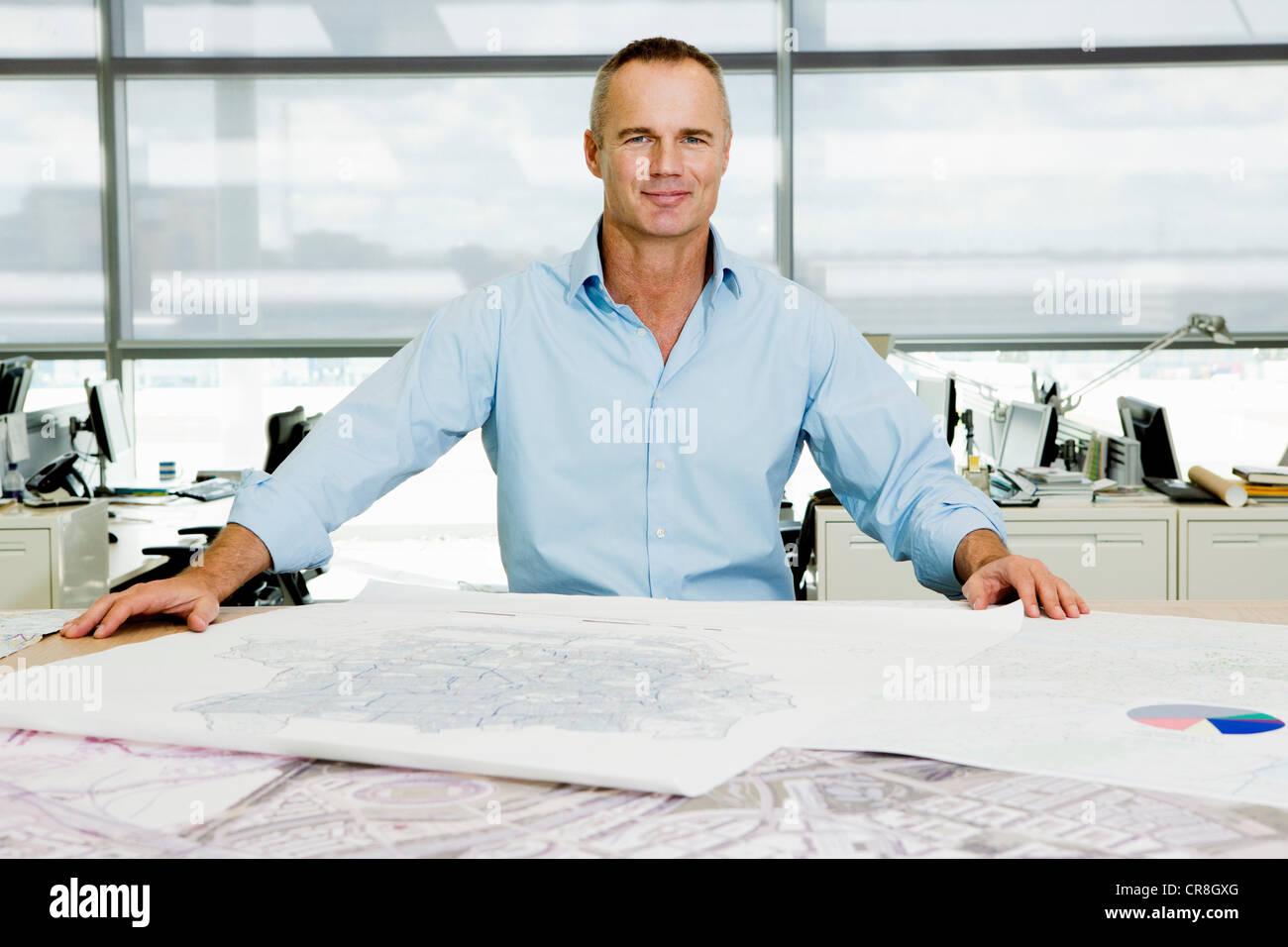 Portrait of an architect working on blueprints in office Stock Photo ...