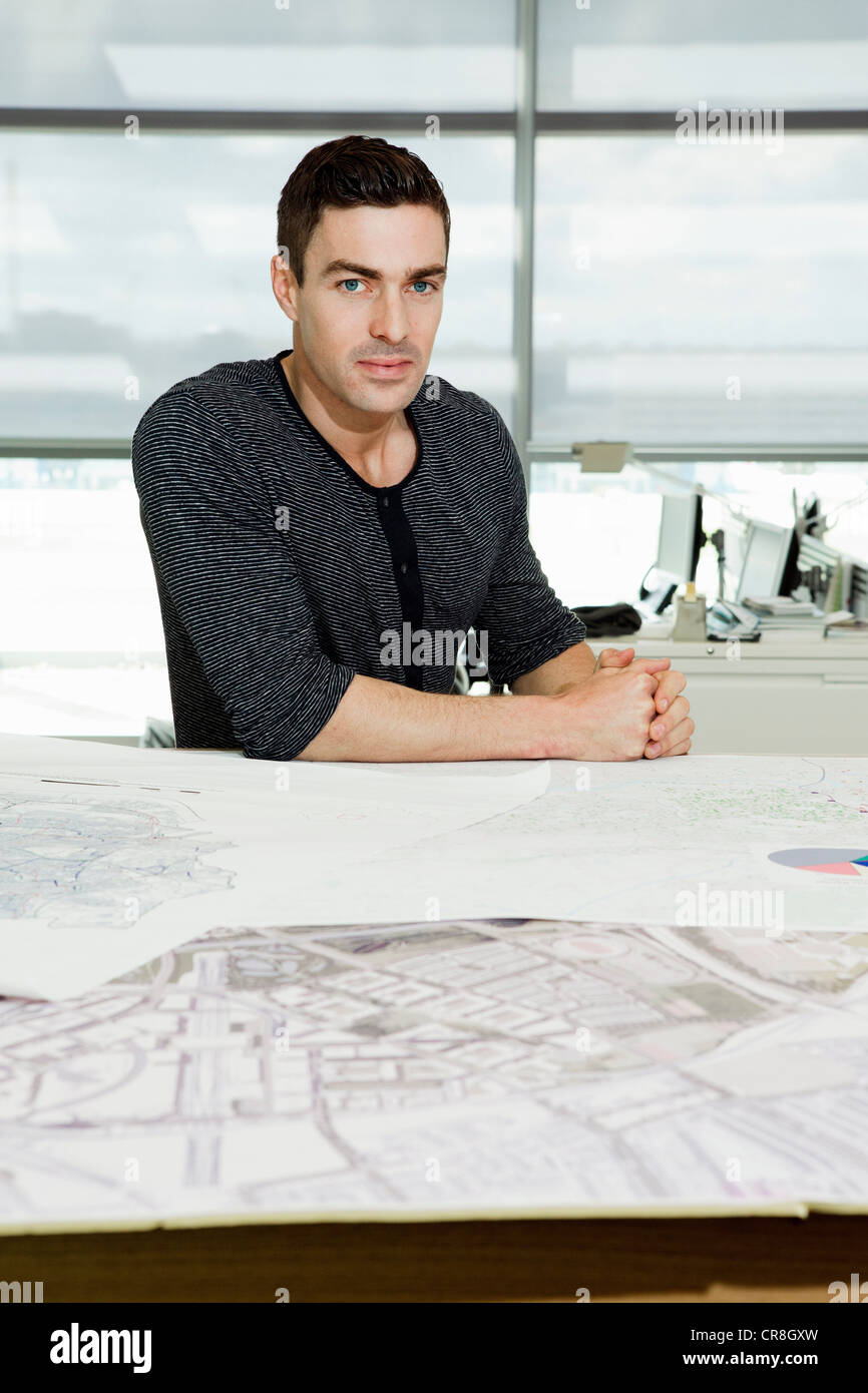 Portrait of an architect working on blueprints in office Stock Photo ...