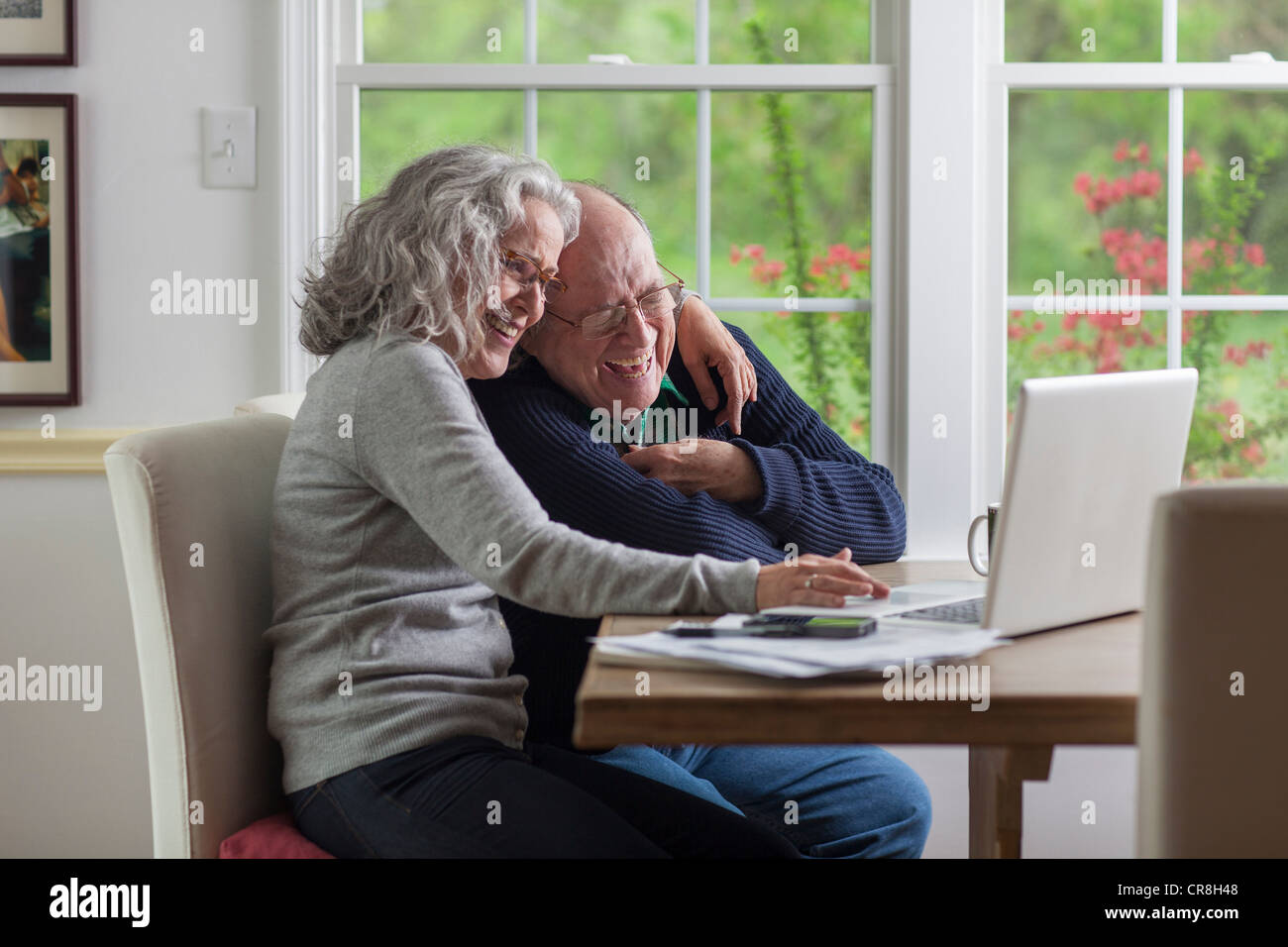 Senior couple using laptop at home, laughing Stock Photo - Alamy