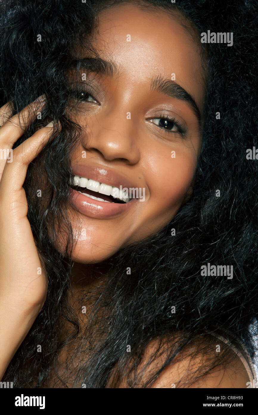 Young woman with hands in hair, close up, portrait Stock Photo - Alamy