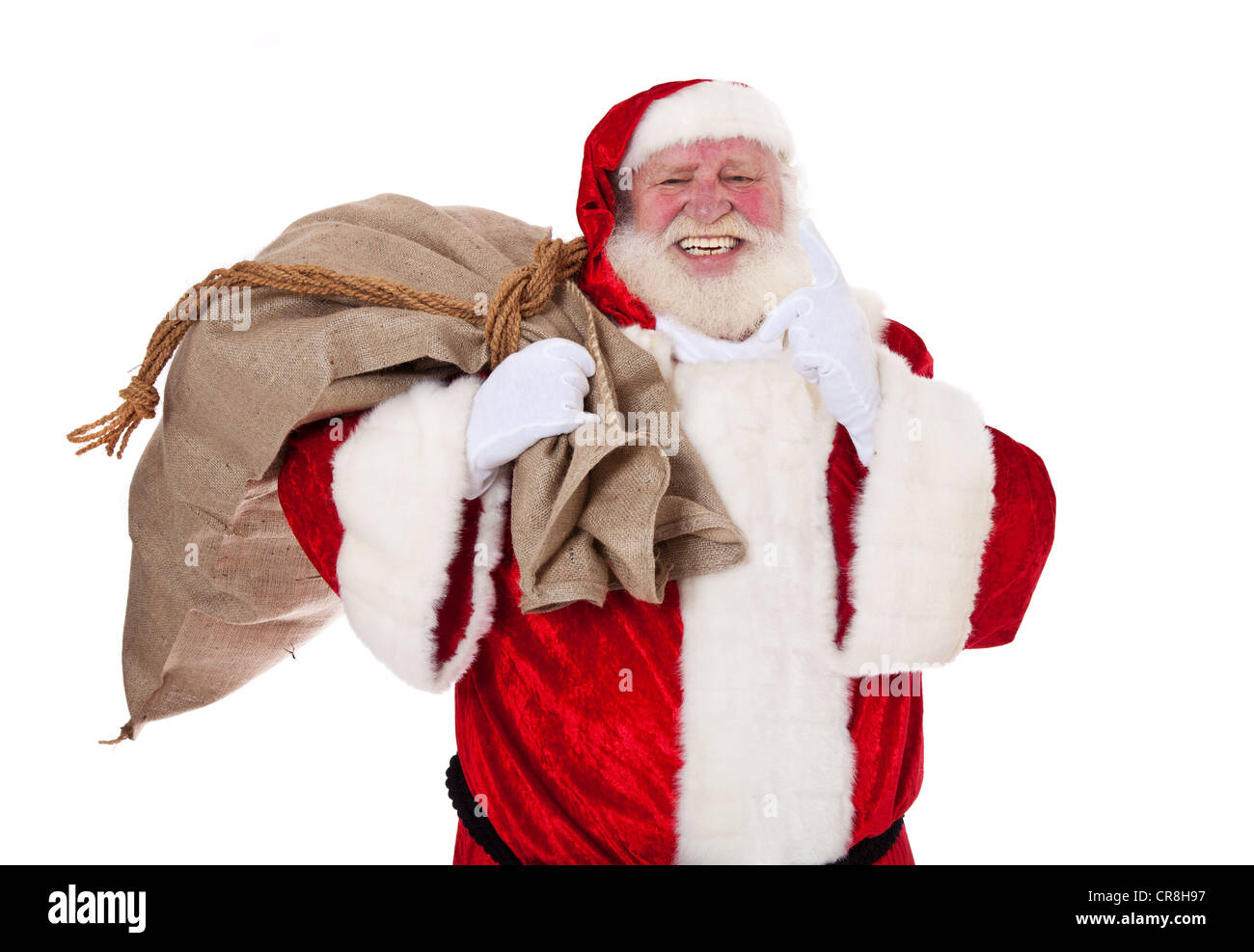 Santa Claus in authentic look carrying bag of presents. All on white ...
