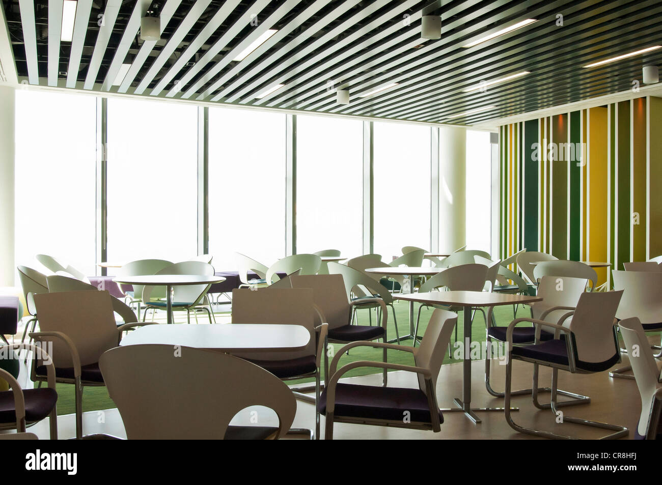 Chairs and tables in empty room of office block Stock Photo - Alamy