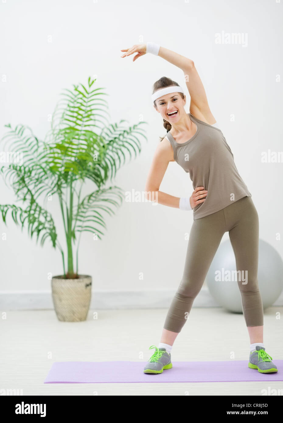 Smiling fitness woman making stretching exercises Stock Photo - Alamy