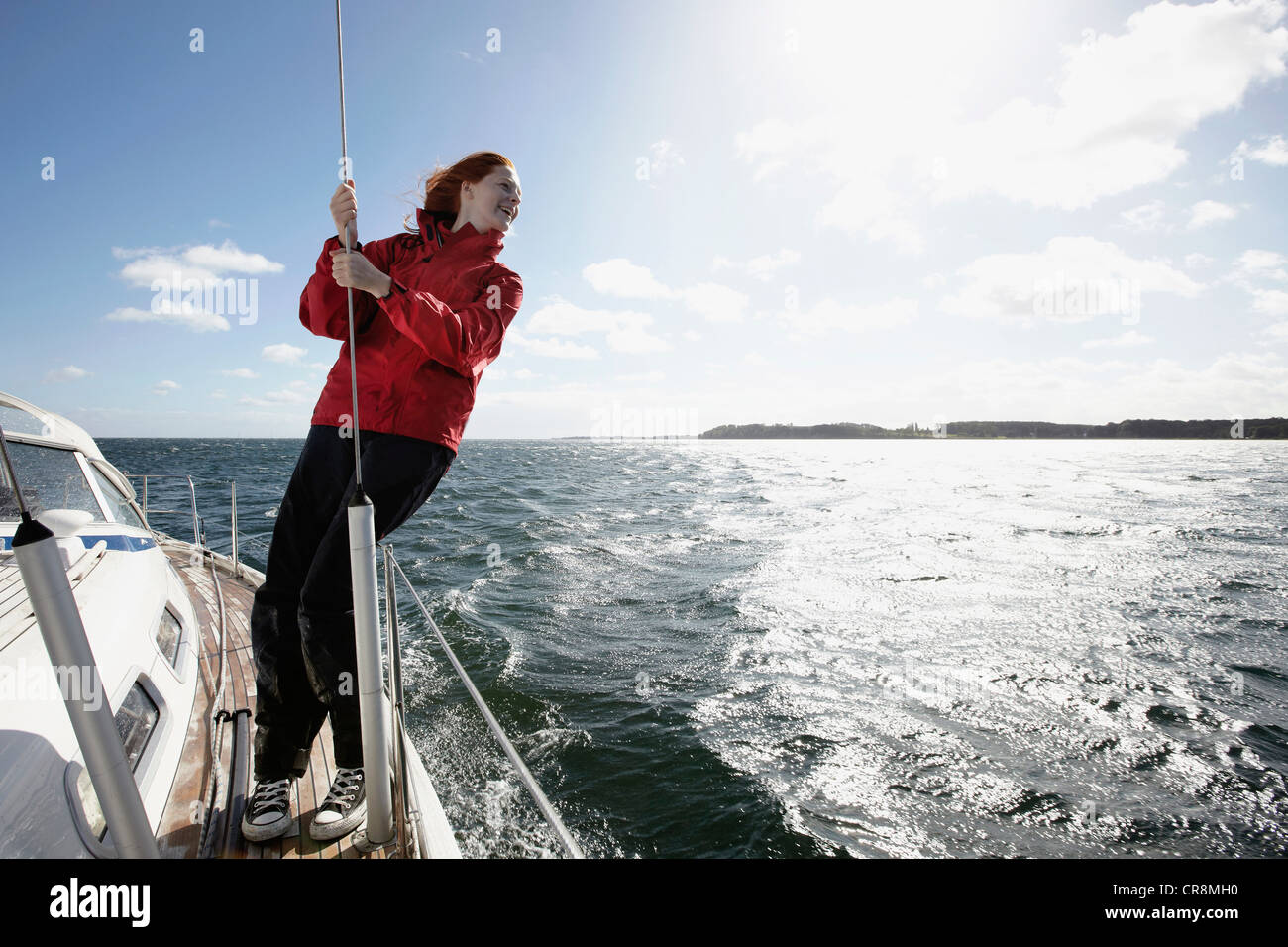 Young woman holding onto rope on yacht Stock Photo - Alamy