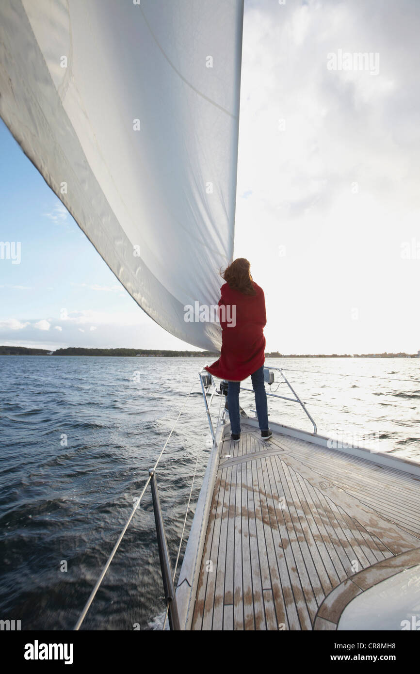 Woman standing by sail on yacht Stock Photo - Alamy