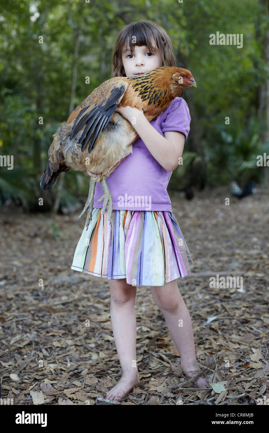 Girl holding hen Stock Photo - Alamy