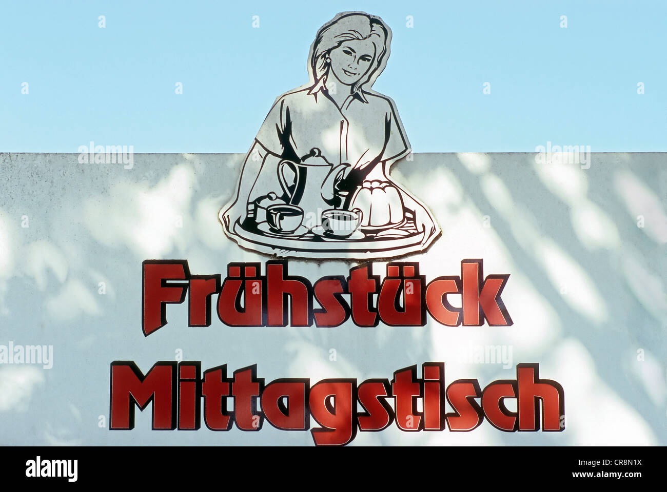 Waitress serving coffee and a cake, advertising sign of a snack bar ...