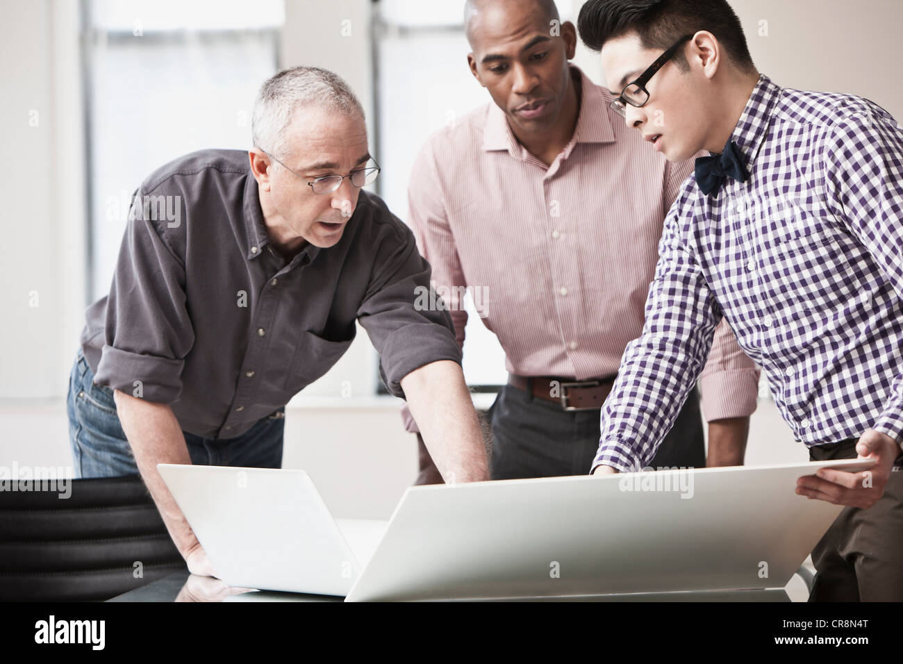 Three business people in meeting Stock Photo - Alamy