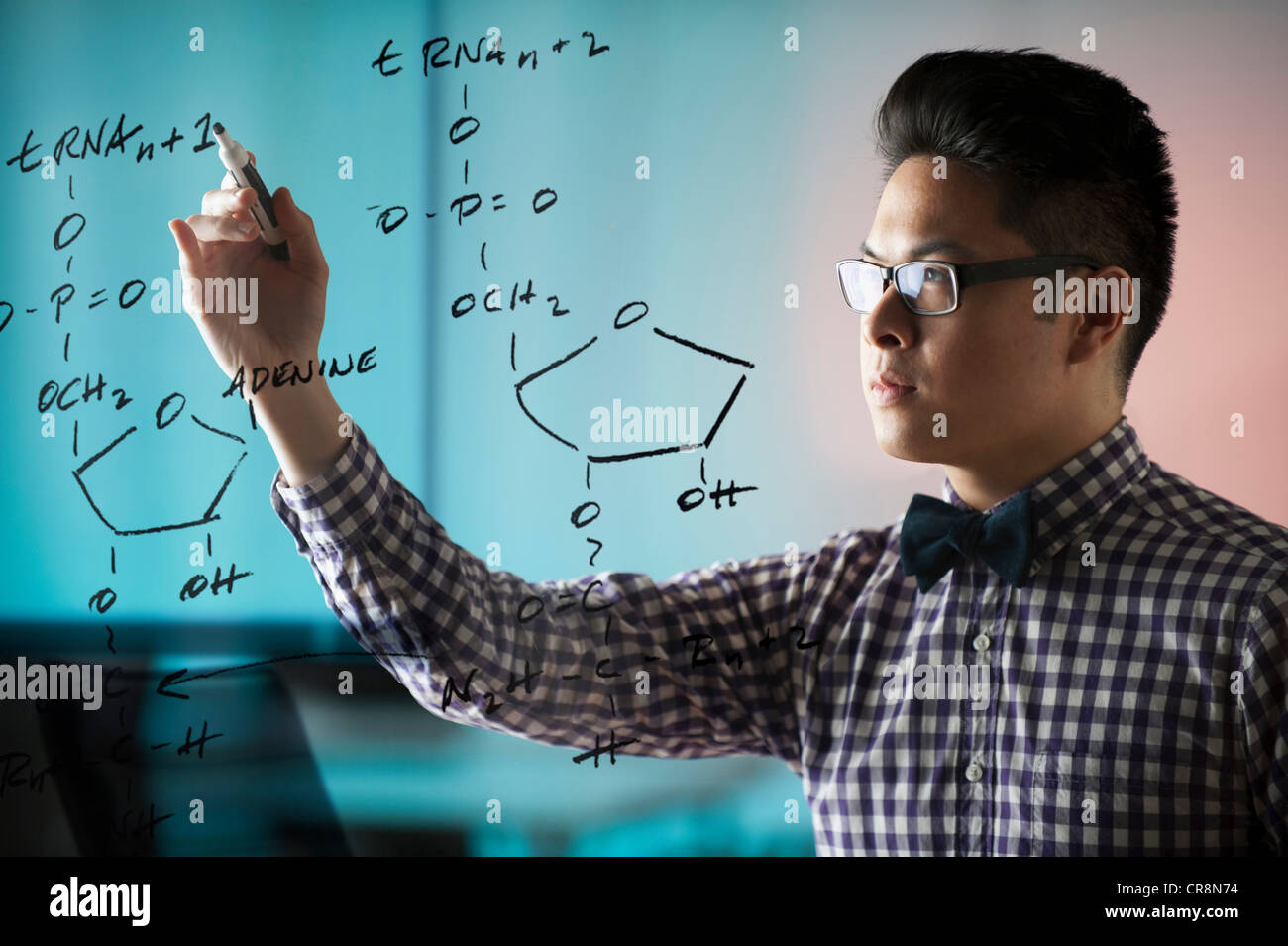 Young man drawing diagram on window Stock Photo - Alamy