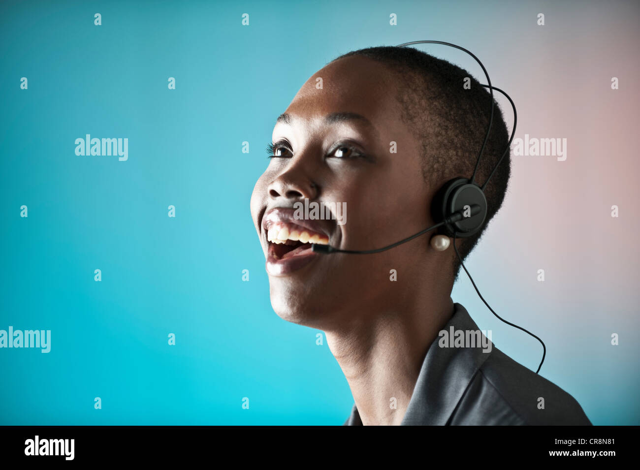 Young woman wearing telephone headset, laughing Stock Photo - Alamy