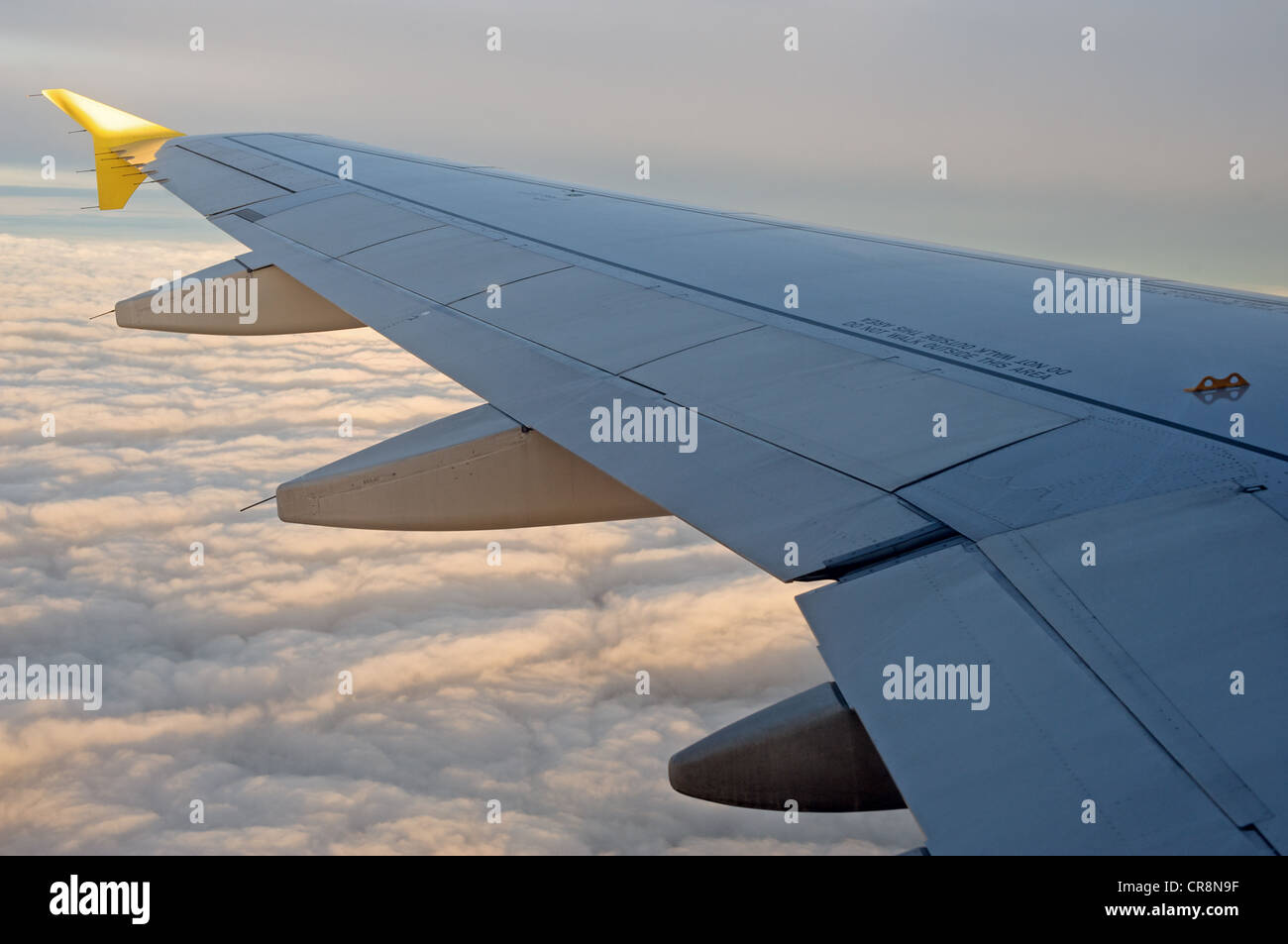 Wing of a commercial airliner over the English channel Stock Photo - Alamy