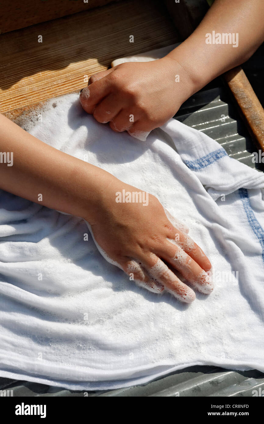 Children's hands washing a linen cloth on a washboard, Flachsmarkt ...