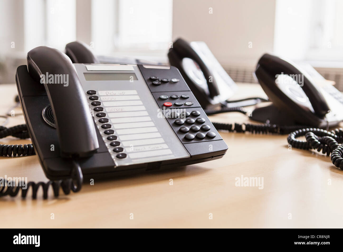 Landline phones on desk Stock Photo - Alamy