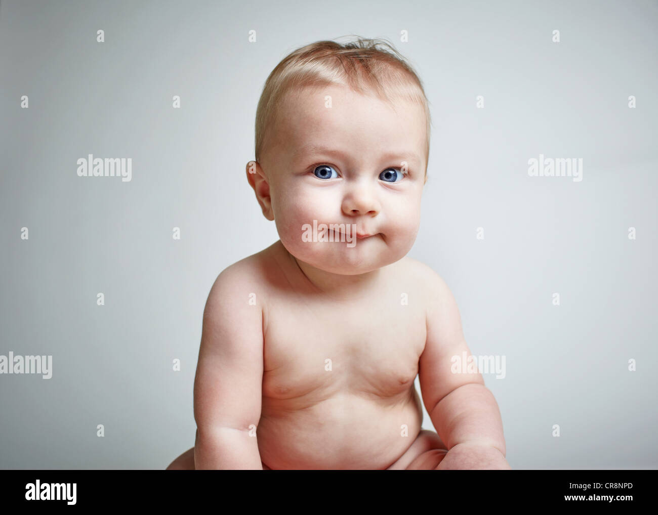 Baby boy making a funny face Stock Photo - Alamy