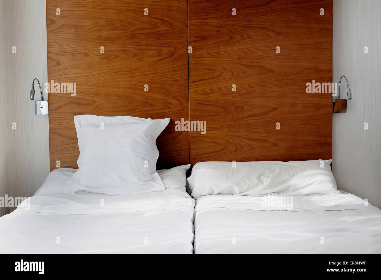 Empty bed with white bed linen Stock Photo - Alamy