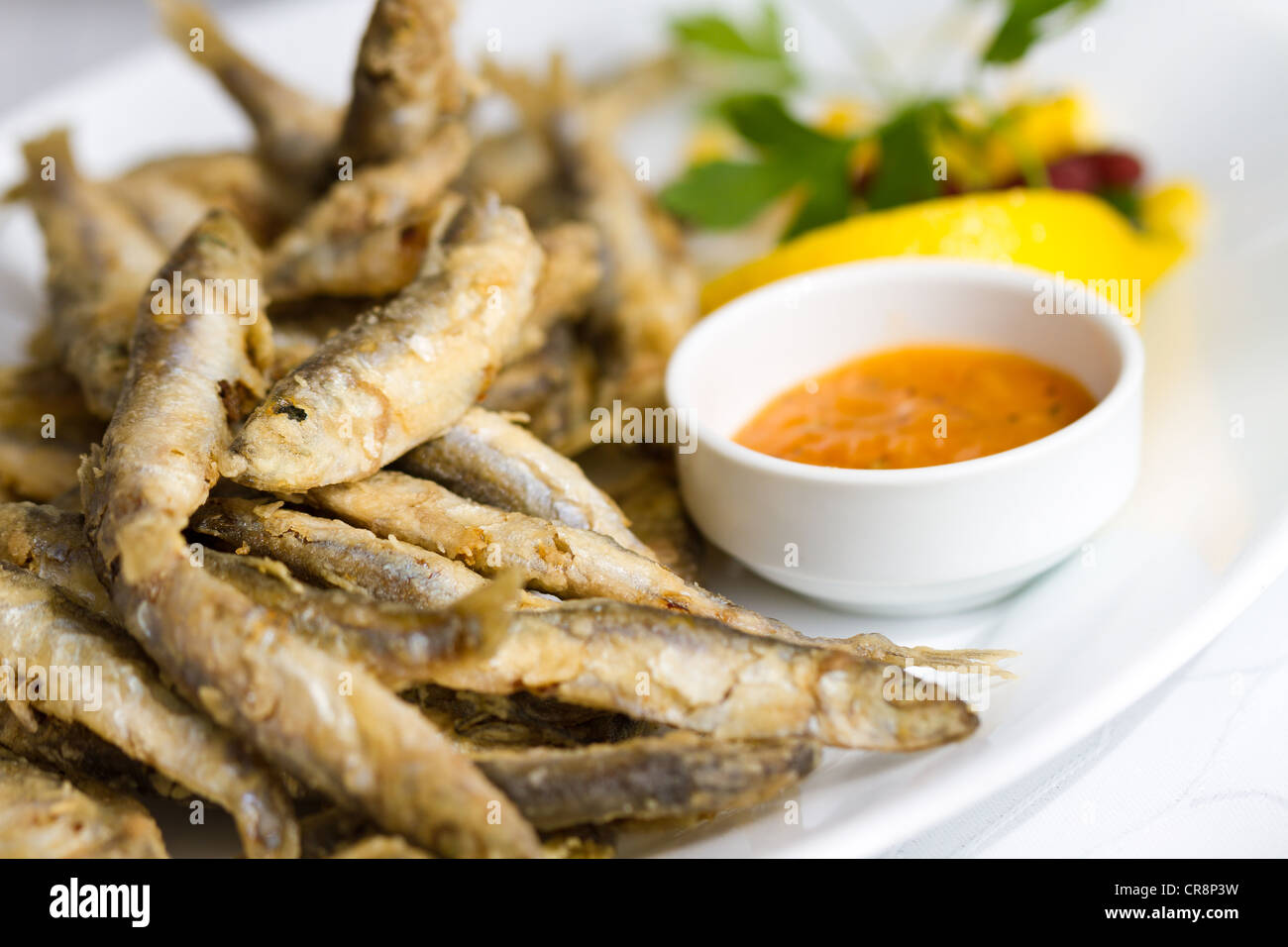 Fried fresh sprat fish with souce. Good seafood Stock Photo - Alamy