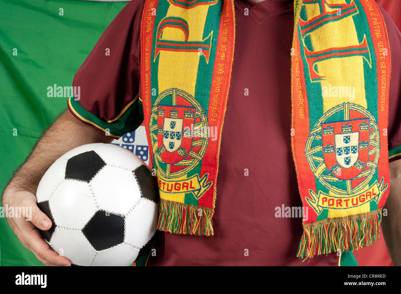 Portugal soccer fan with a ball and scarf and the Portuguese flag as ...