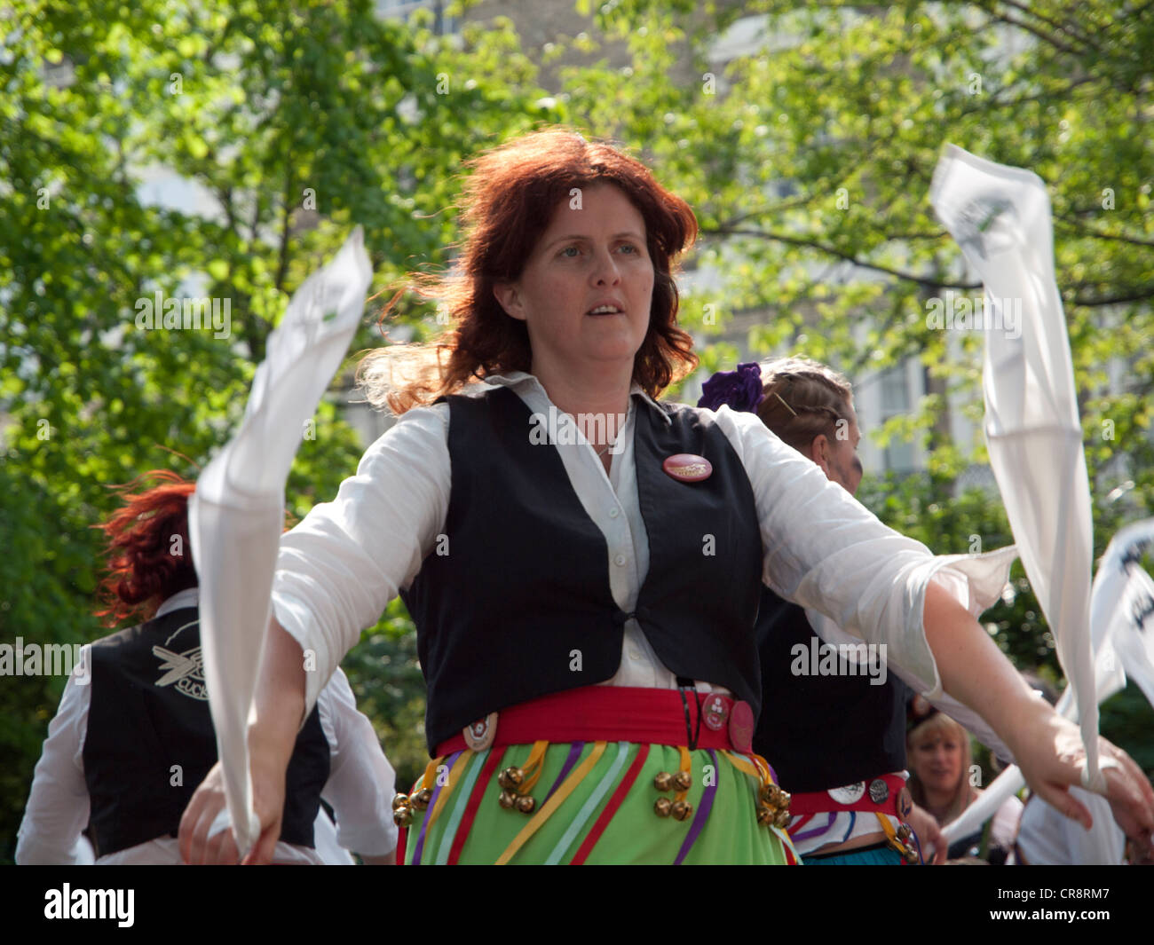 A female dancer at a Morris dancing festival in Brighton twirls her ...