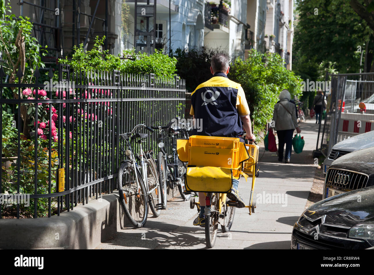 Postman on a bicycle in the Eppendorf district, Hamburg, Germany ...