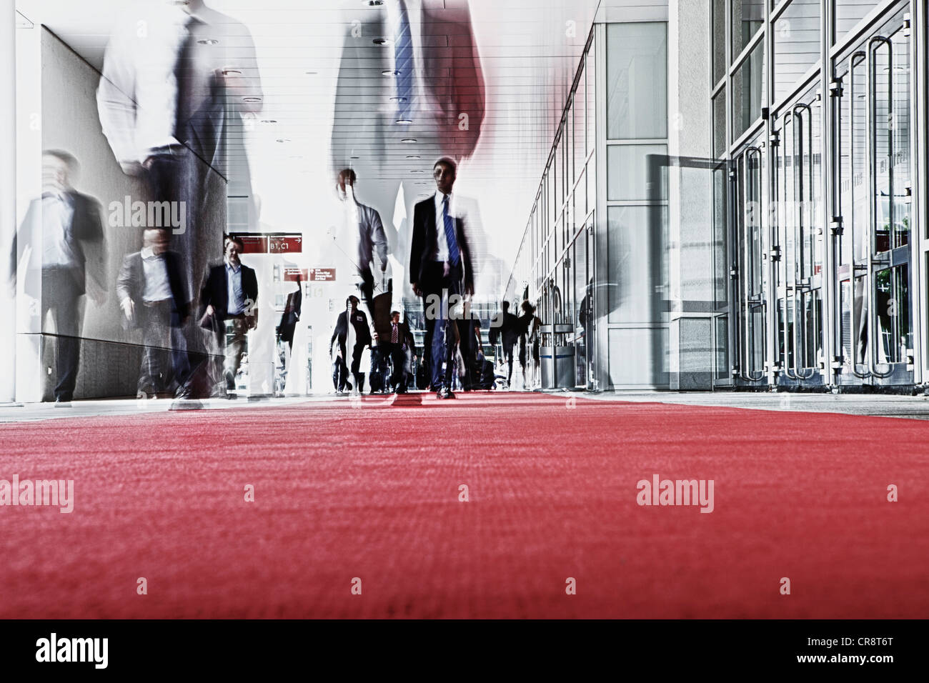 Business people walking on a red carpet Stock Photo - Alamy