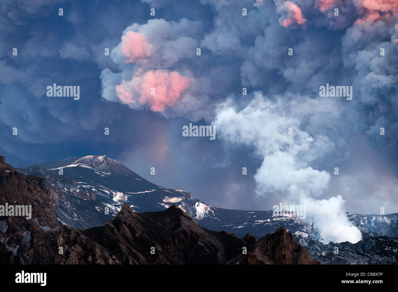 Ash-covered landscape and a vapor cloud under the sun-drenched morning ...
