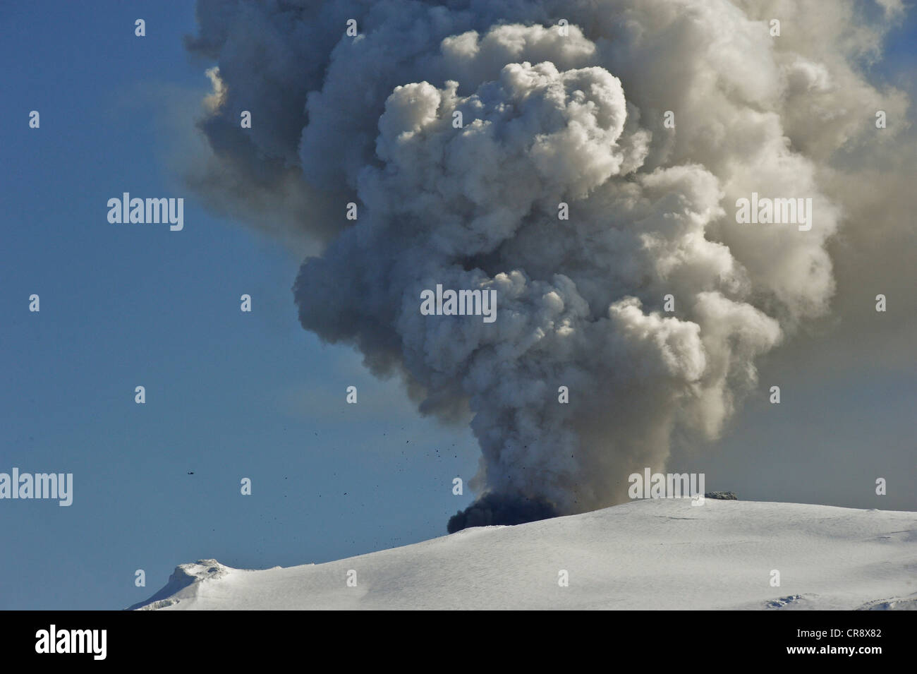 A helicopter flying in close proximity to the crater of ...