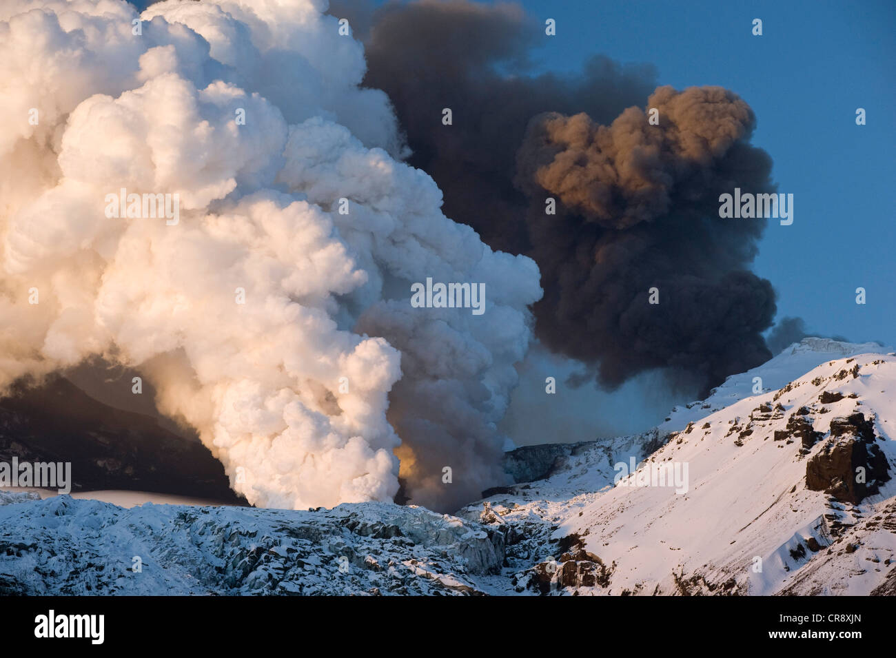 Cloud of ash from Eyjafjallajoekull volcano and a steam plume from the ...