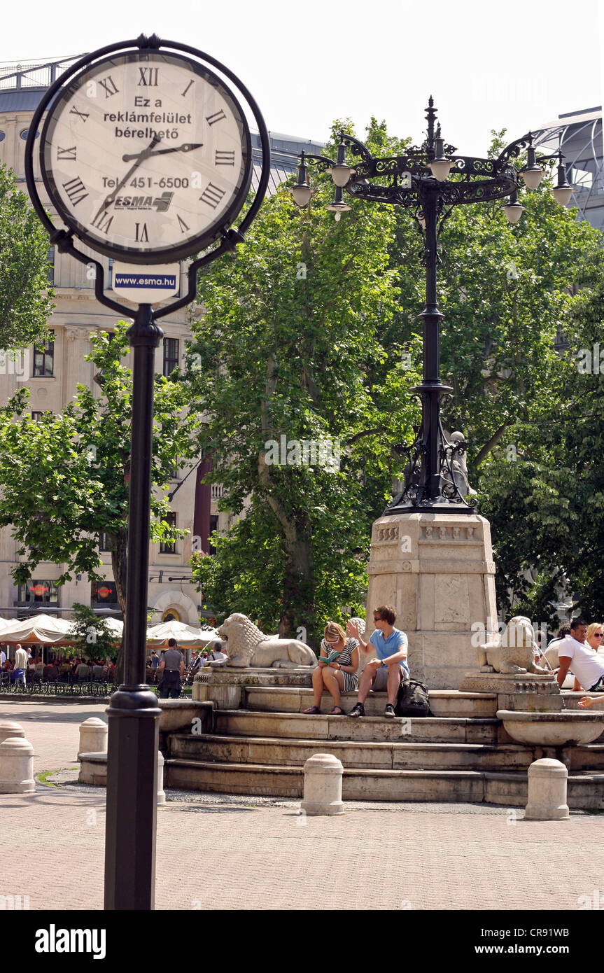 A clock in Vörösmarty square – with Lion Fountain. Vörösmarty tér or ...