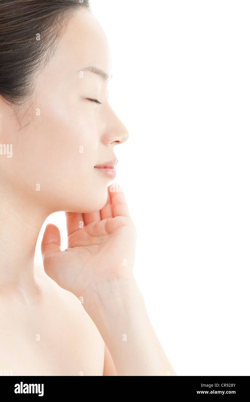 A young woman taking care of face skin Stock Photo - Alamy