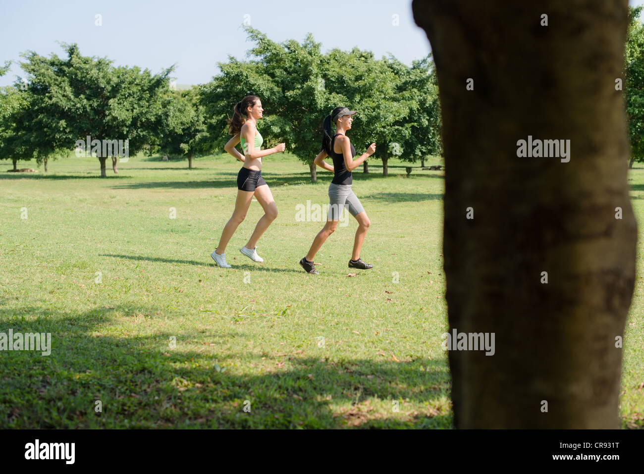Sports and fitness with two female teenagers exercising in city park ...