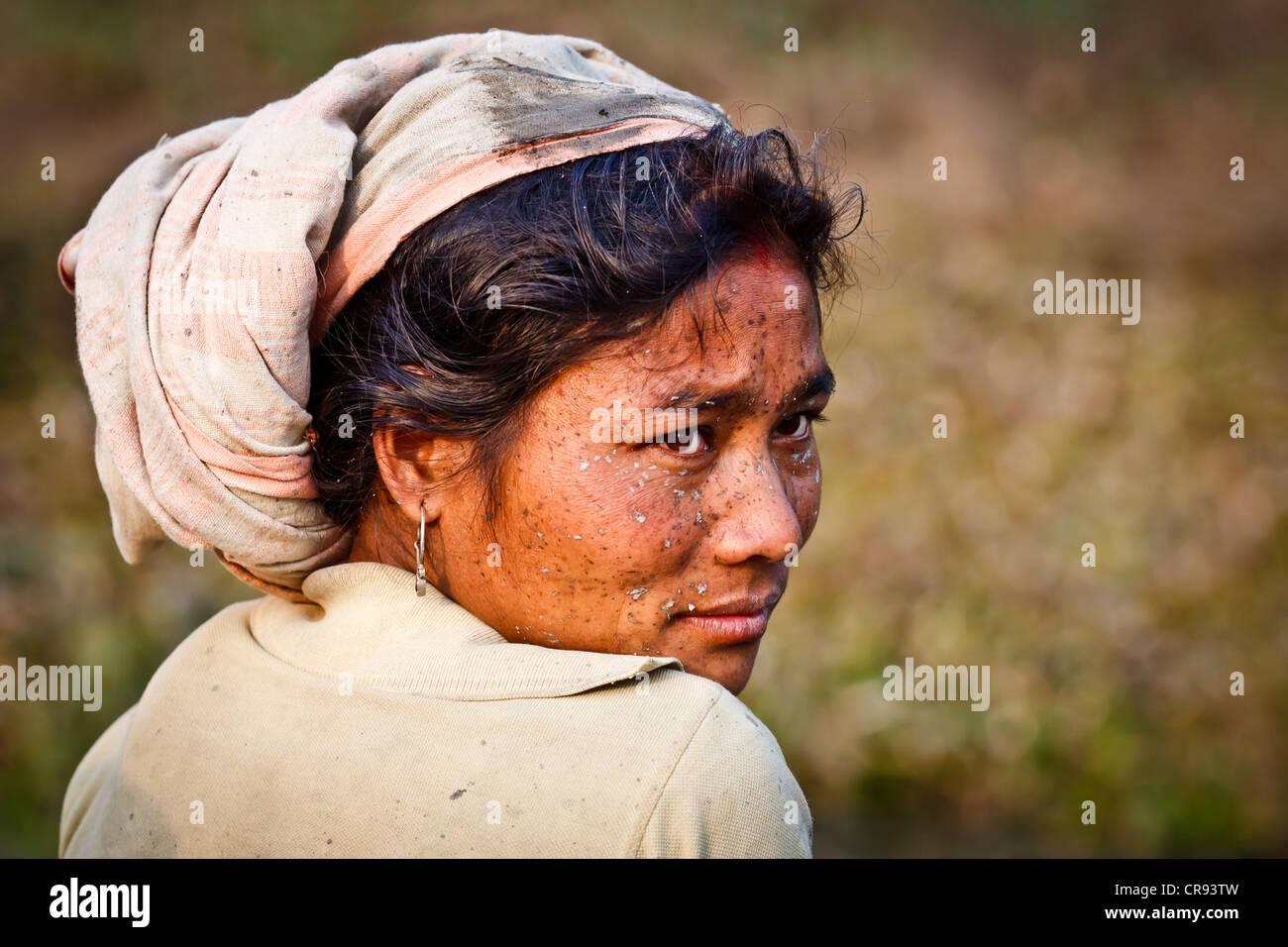Fishing woman from the Mishing tribe wearing Assamese scarf, Majuli ...