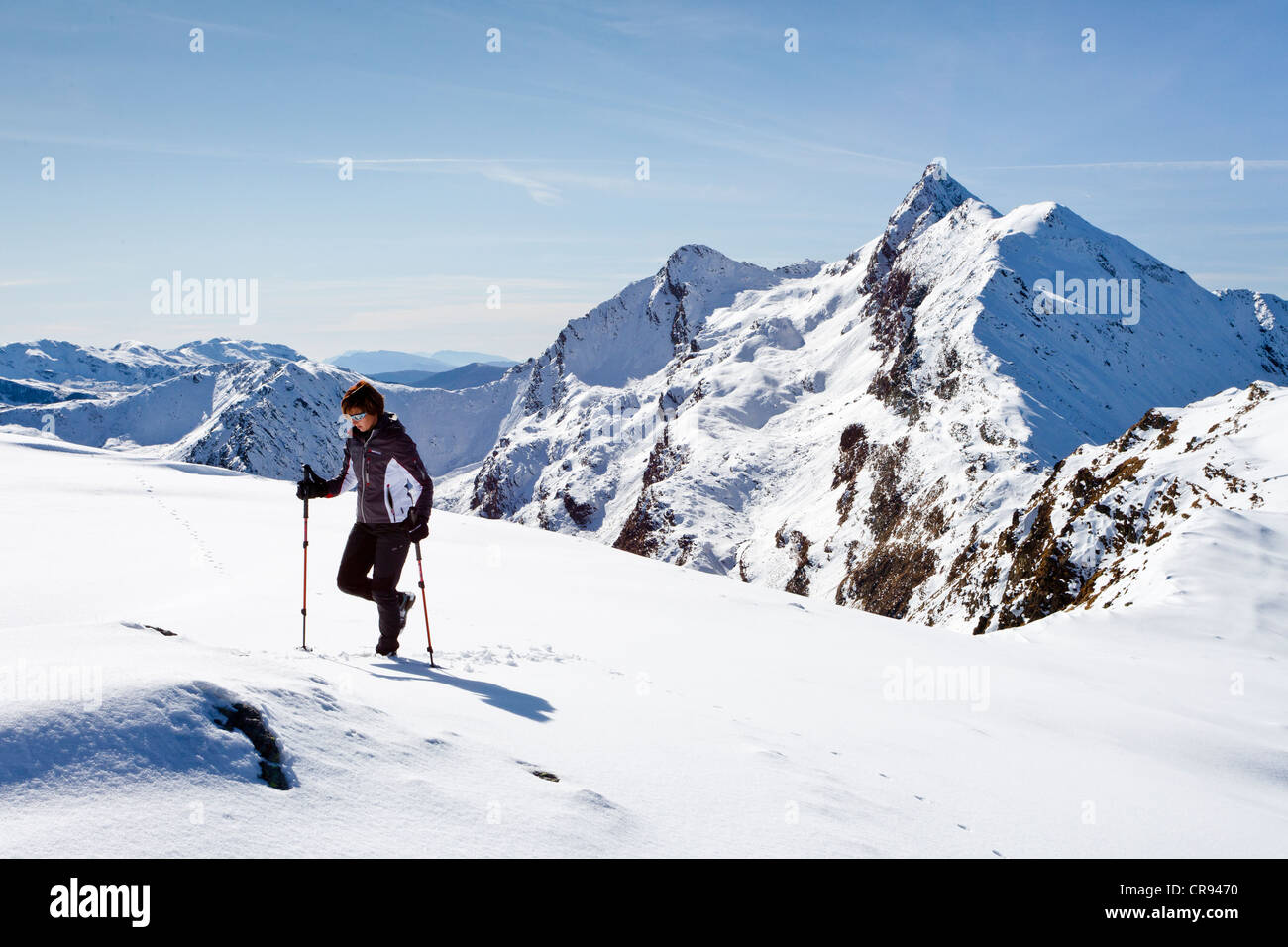 Hiker on the Roethenspitz peak above the Penser Joch pass, behind the ...