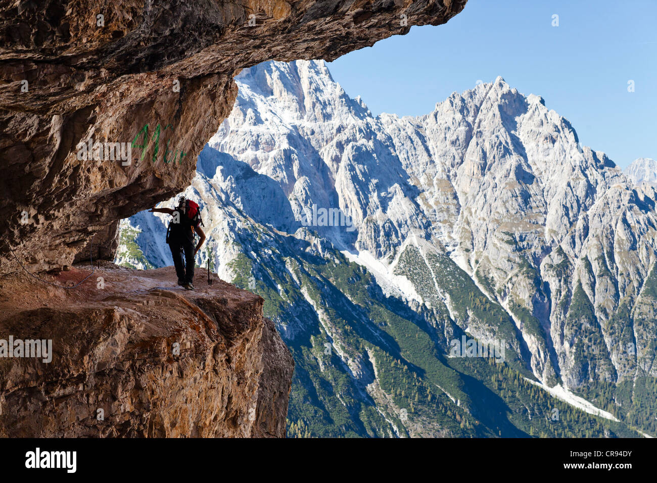 Hiker ascending the Alpinisteig Climbing Route, Sexten, High Puster ...