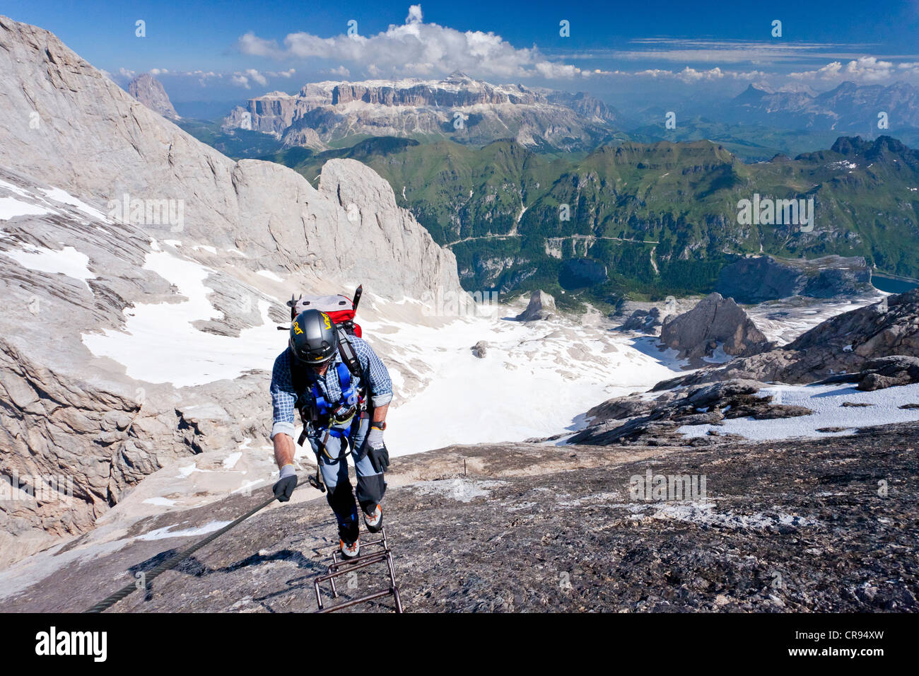 Mountain climber ascending Marmolada Mountain on the Westgrat climbing ...