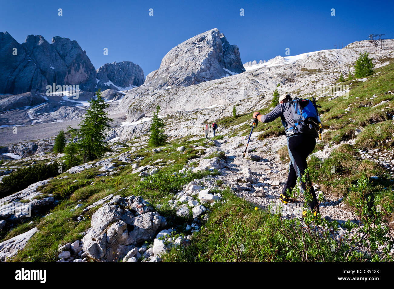 Mountain climber ascending towards Marmolada Mountain on the Westgrat ...