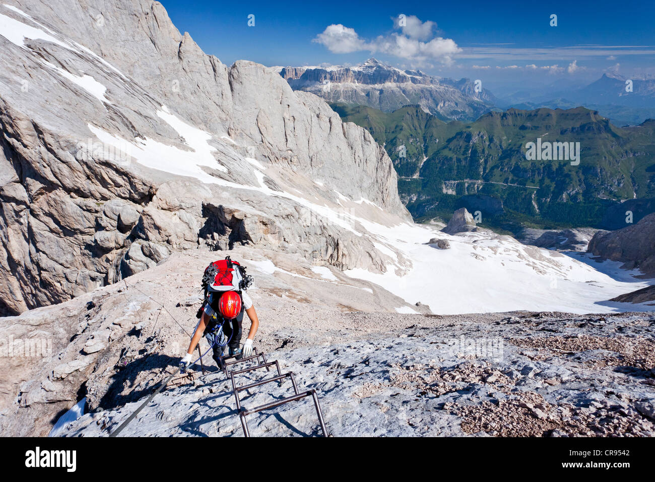 Mountaineer climbing Marmolada mountain, Dolomites, Westgrat fixed rope ...