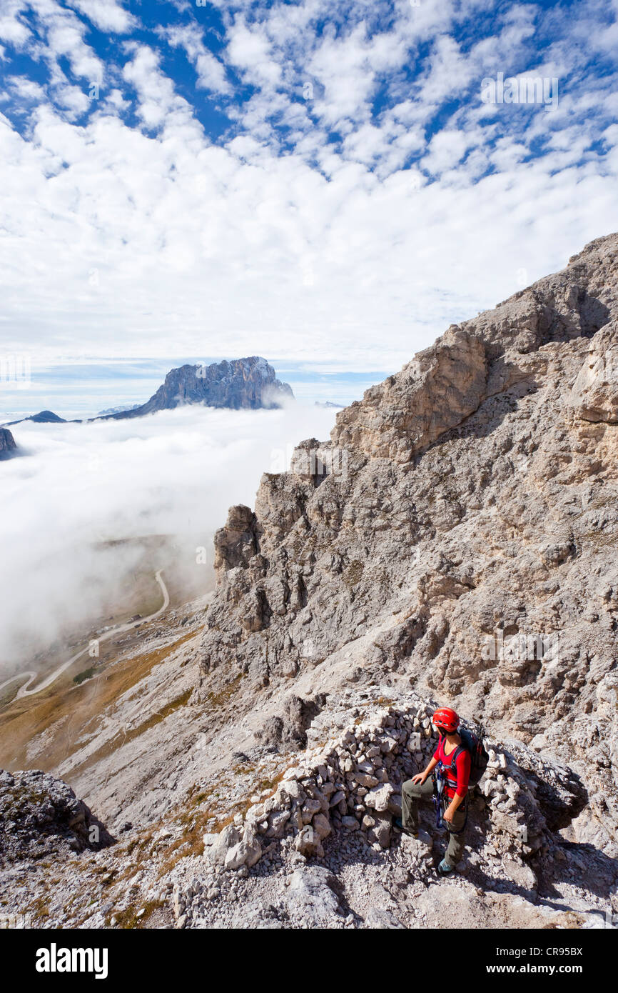 Climber climbing Gran Cir mountain above the fixed rope route above the ...