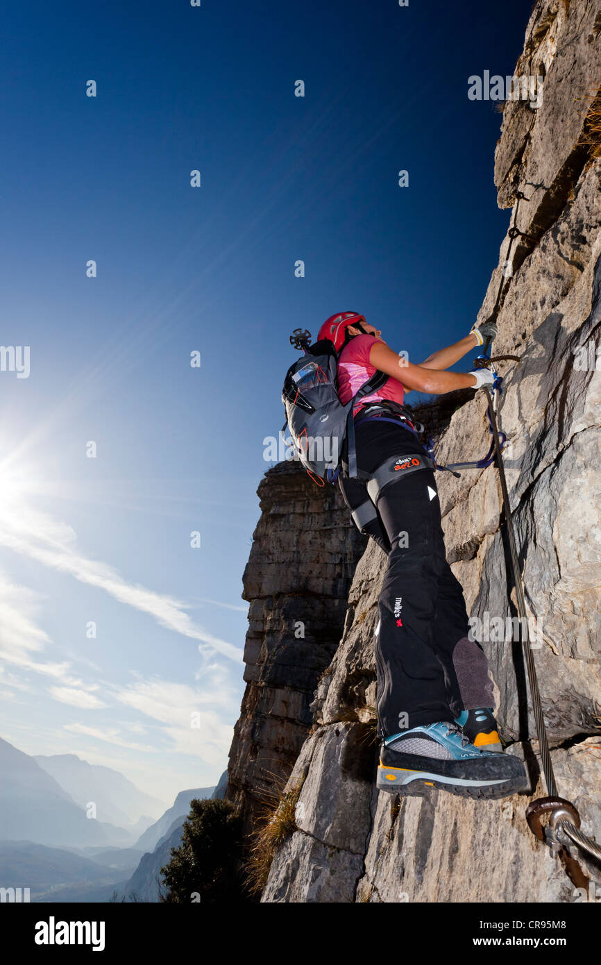 Female climber climbing on the Rino Pisetta fixed rope route, Sarchetal ...