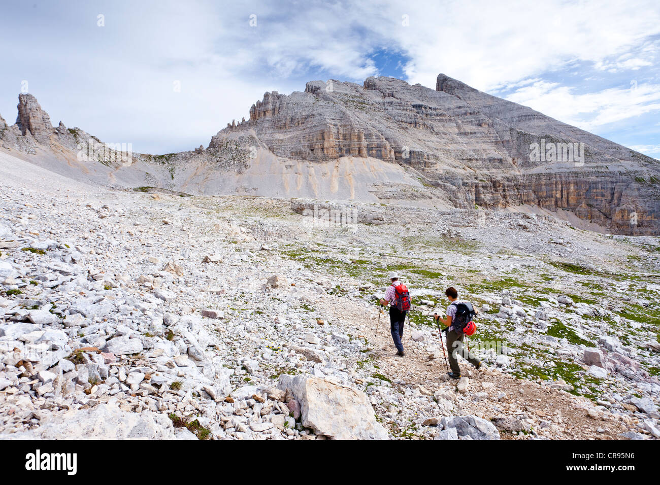 Hikers on the Latemar crossing, fixed rope route, Latemar mountain ...