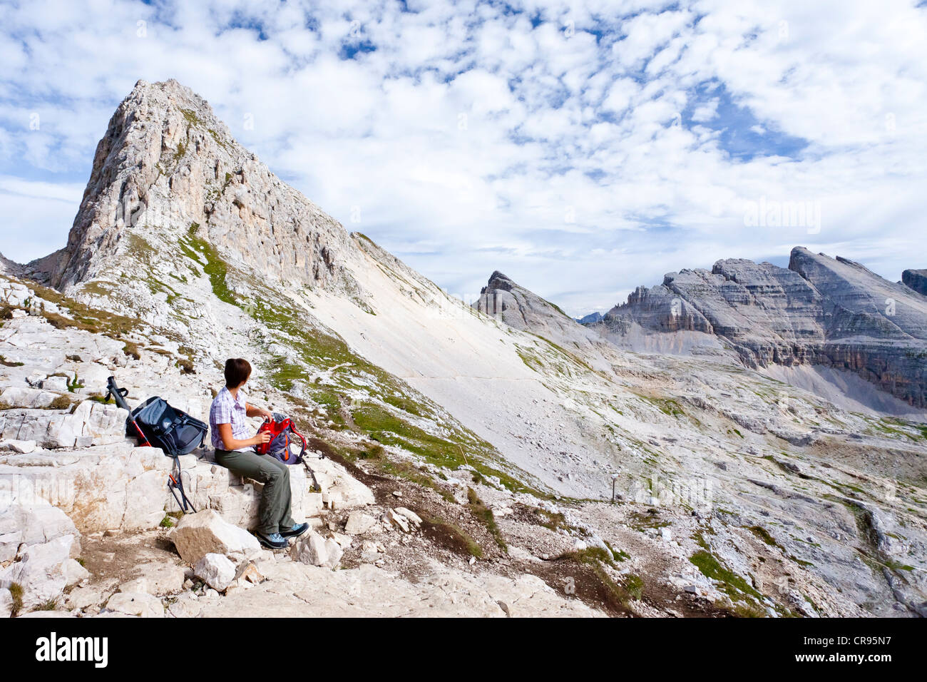 Hiker on the Latemar crossing, fixed rope route, Latemar mountain range ...